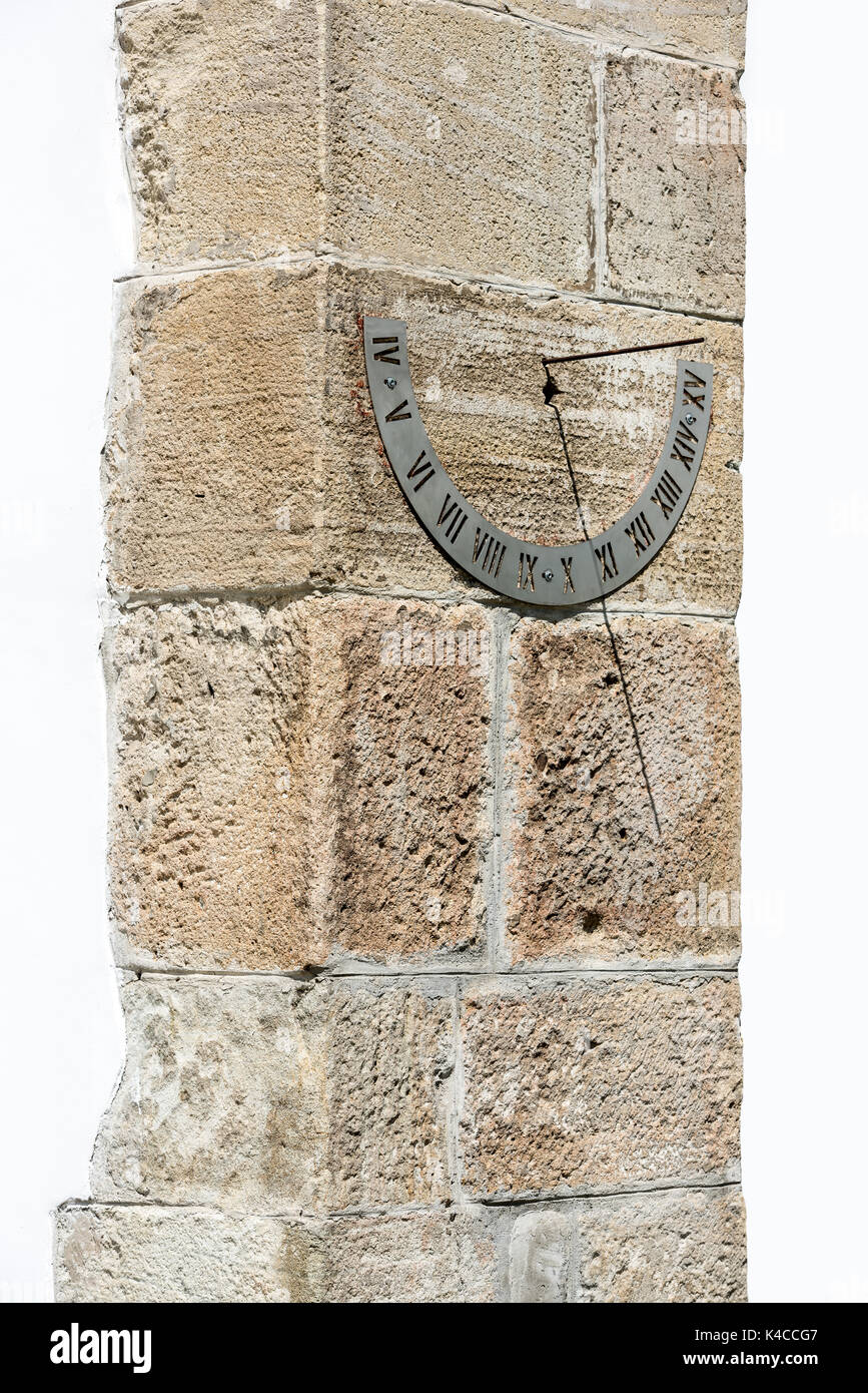 Old fashioned sun dial on a stone wall isolated on white. Solar Clock ...