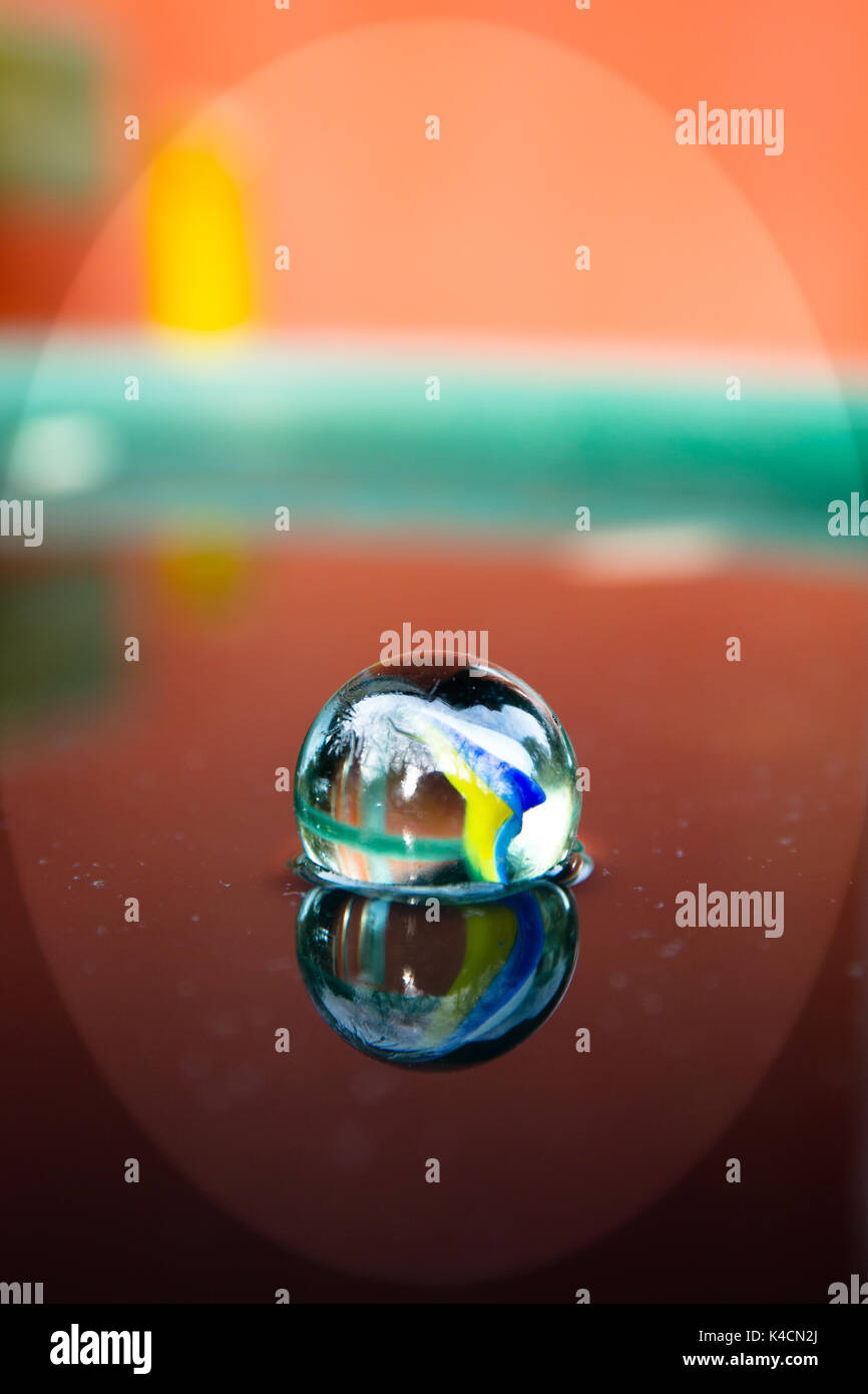 Glass Marbles With Reflection In Front Of Colorful Background Stock ...