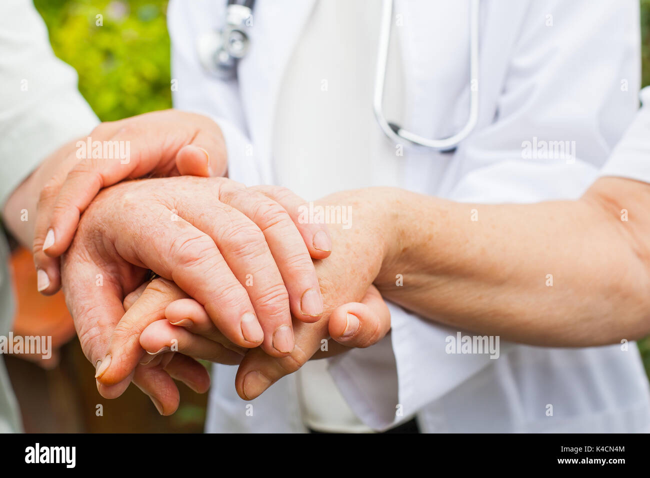 Close up medical doctor holding elderly patients shaking hands ...