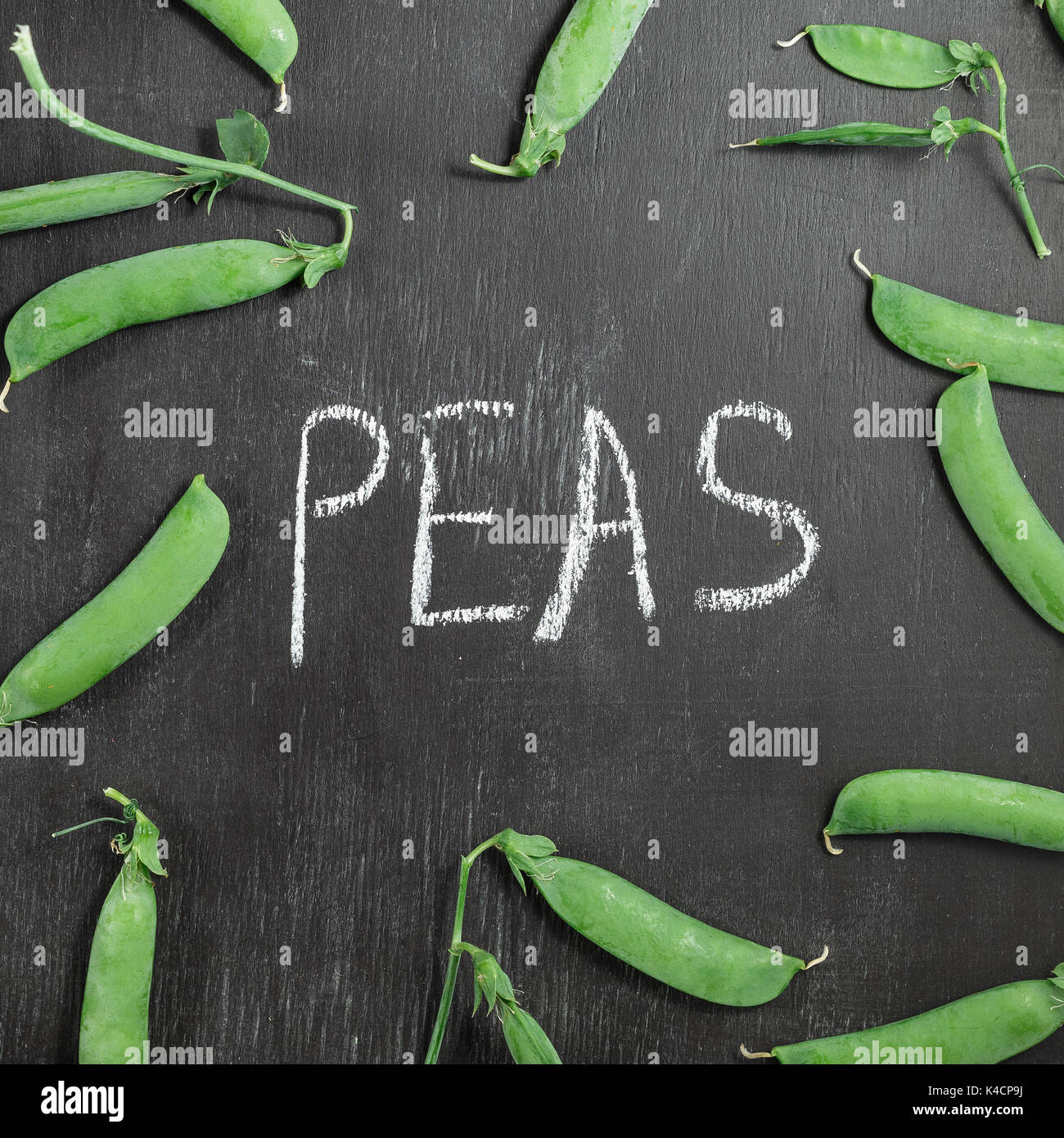 Green peas on black chalk board, the word peas written on blackboard ...