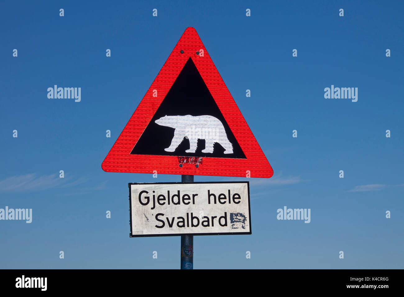 Polar bear warning sign against blue sky, Spitsbergen / Svalbard Stock ...