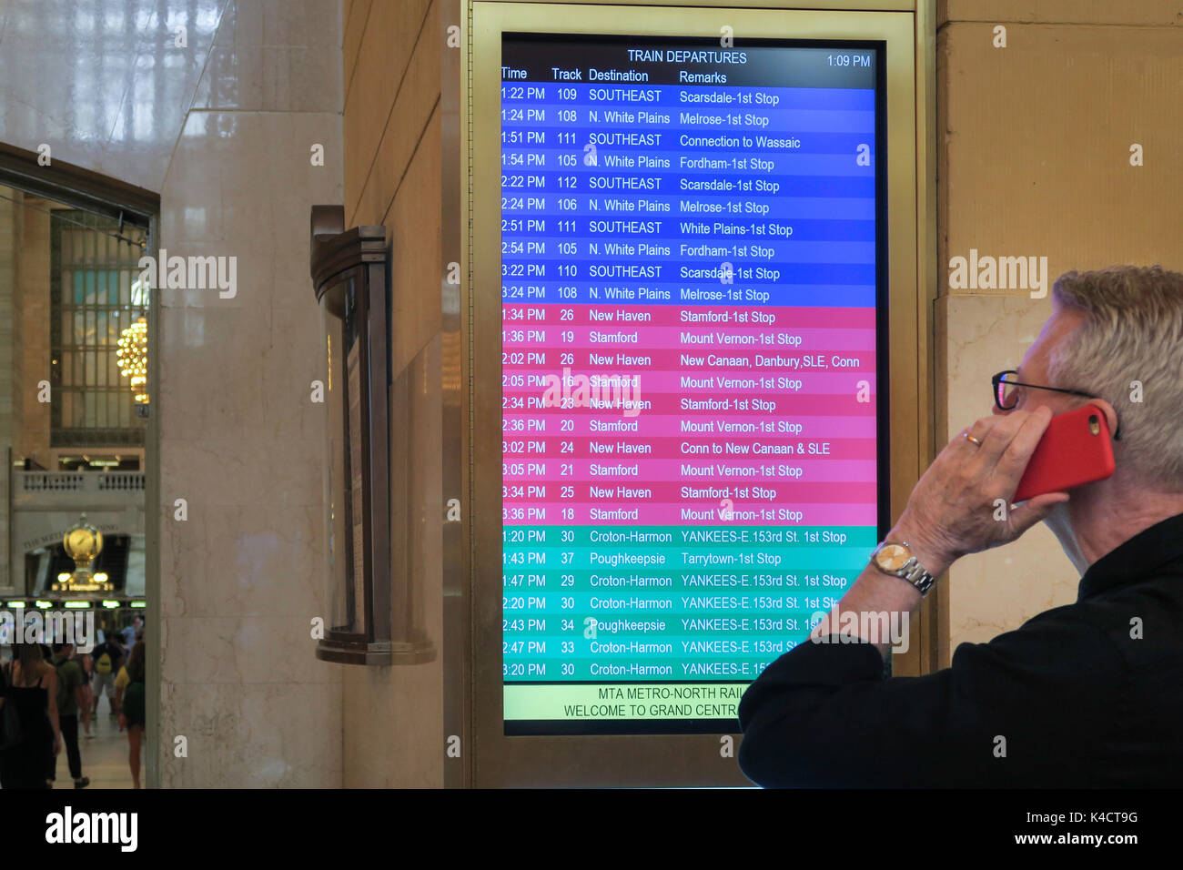 Senior Man Checking Train Departures Board in Grand Central Terminal ...