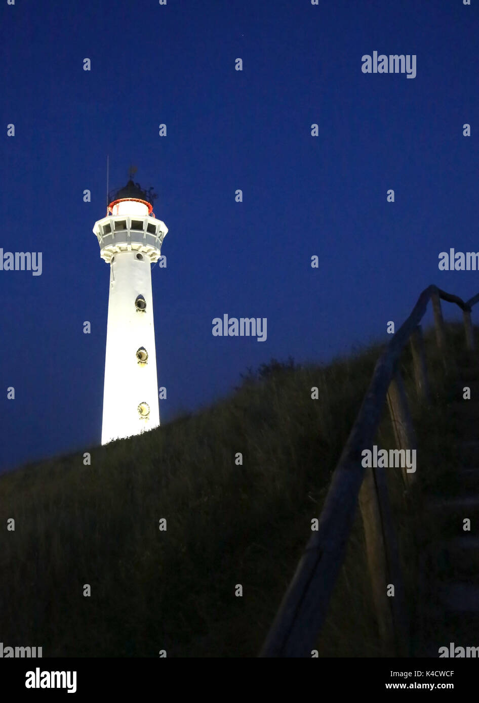 Great white illuminated light in the cliff at night Stock Photo - Alamy