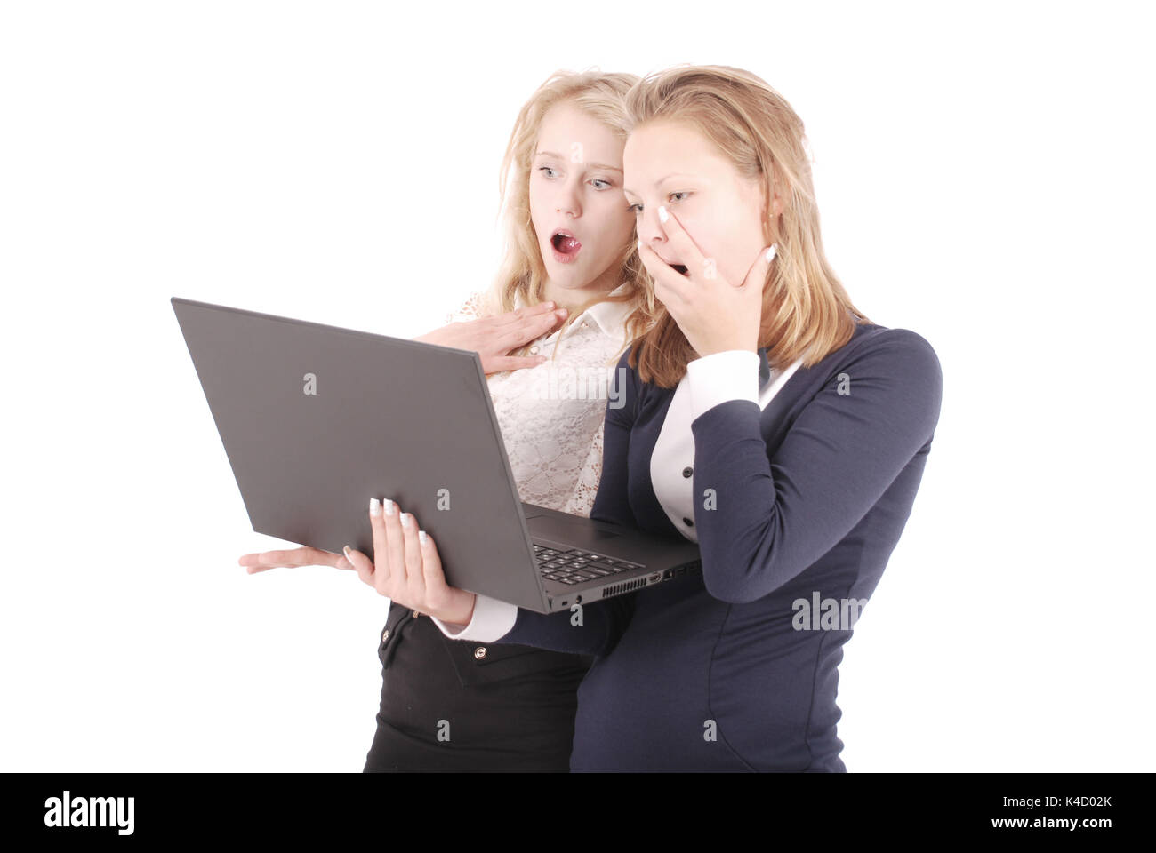 Two shocked girls using laptop isolated on a white background Stock ...