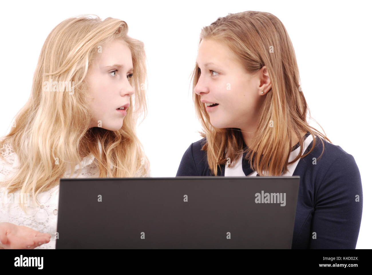 Two shocked girls using laptop isolated on a white background Stock ...
