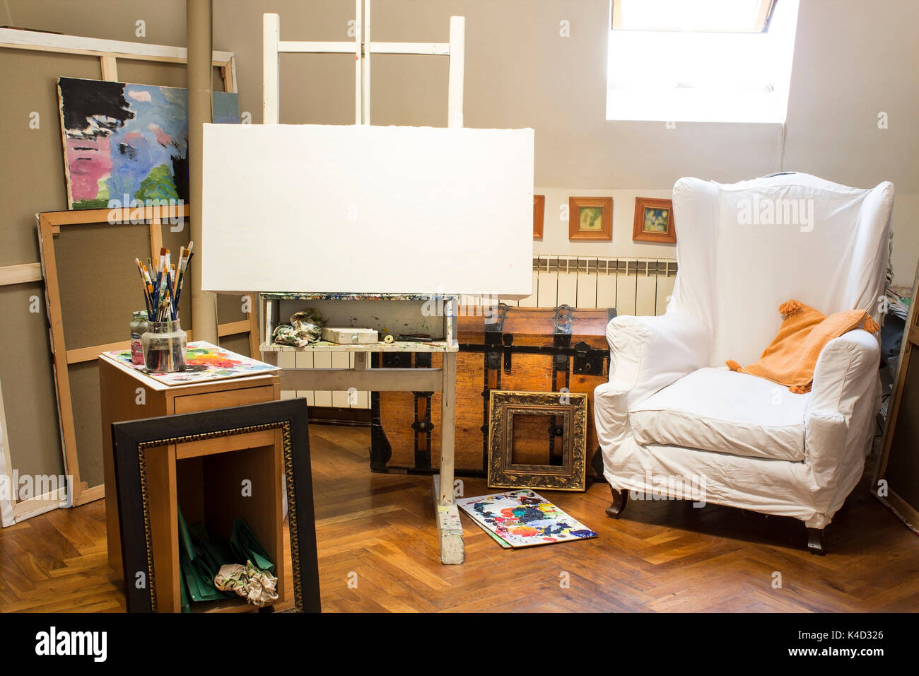 Art studio with paintings and painting equipment Stock Photo - Alamy