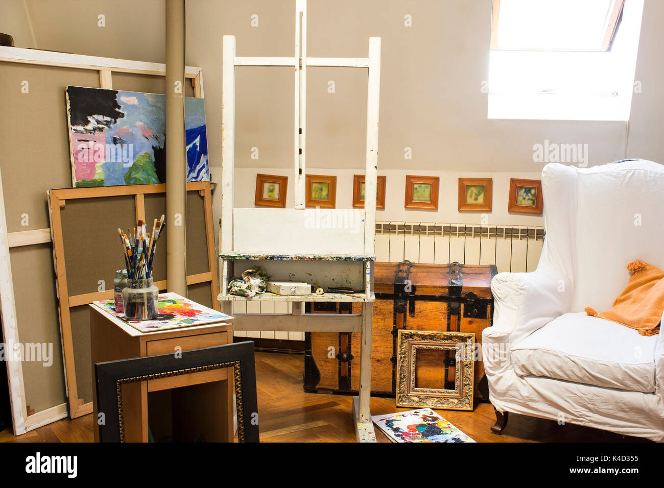 Art studio with paintings and painting equipment Stock Photo - Alamy