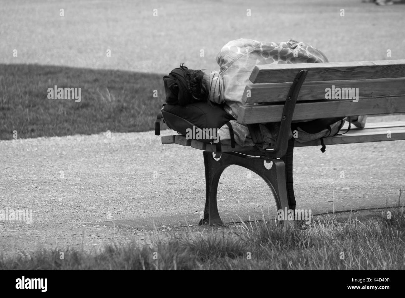 Rough sleeper park bench Black and White Stock Photos & Images - Alamy