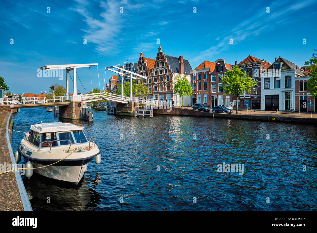 Spaarne river with boat and Gravestenenbrug bridge in Haarlem, N Stock ...