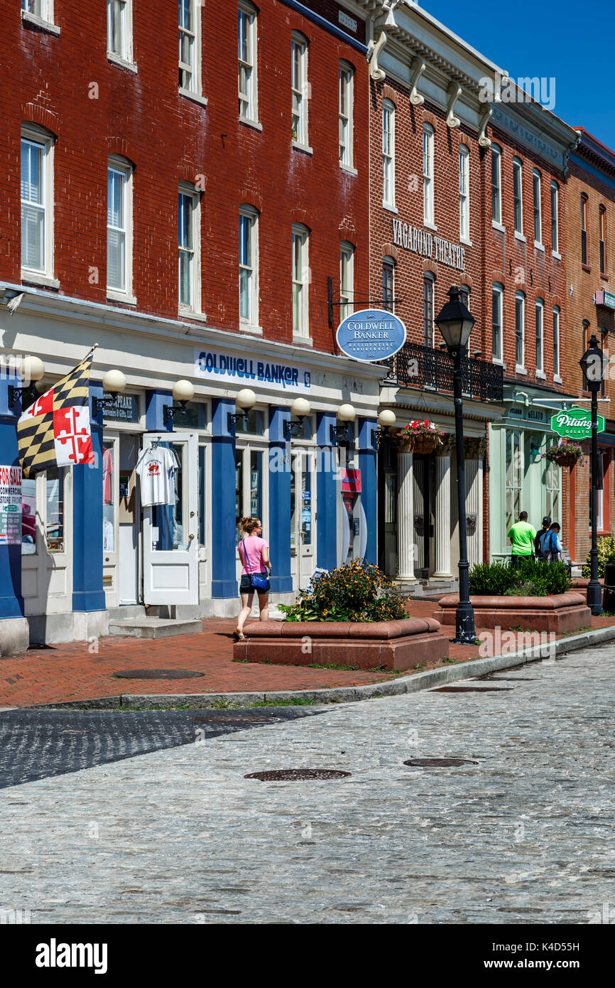 People strolling in front of shops and stores in historic buildings ...