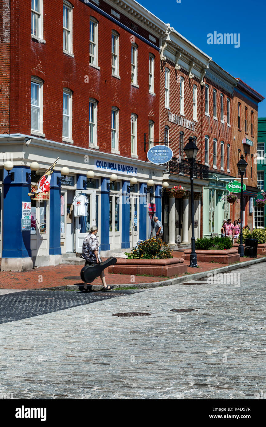 People strolling in front of shops and stores in historic buildings ...