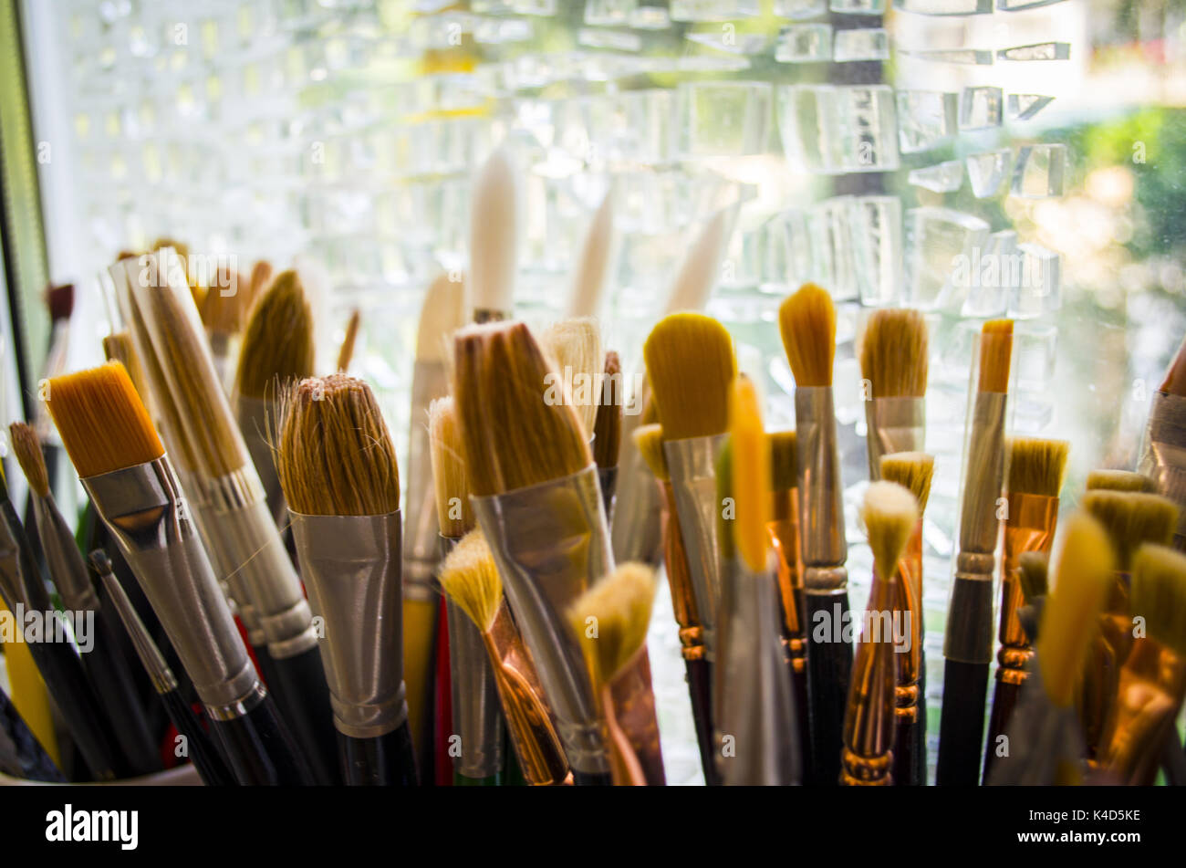 Paint brushes in front of the window Stock Photo - Alamy