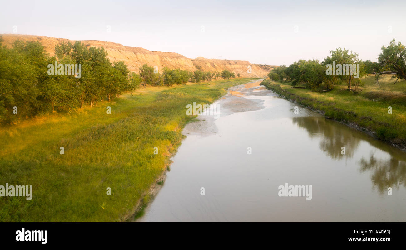 The Little Missouri River flows along beneath buttes in Montana canyons ...