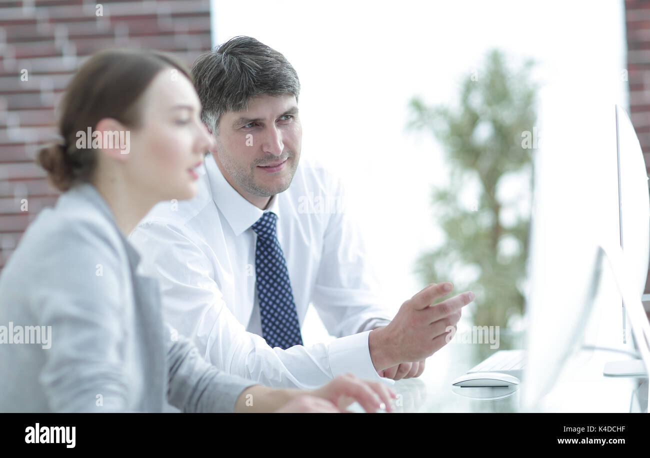 Manager and assistant work with a PC Stock Photo - Alamy