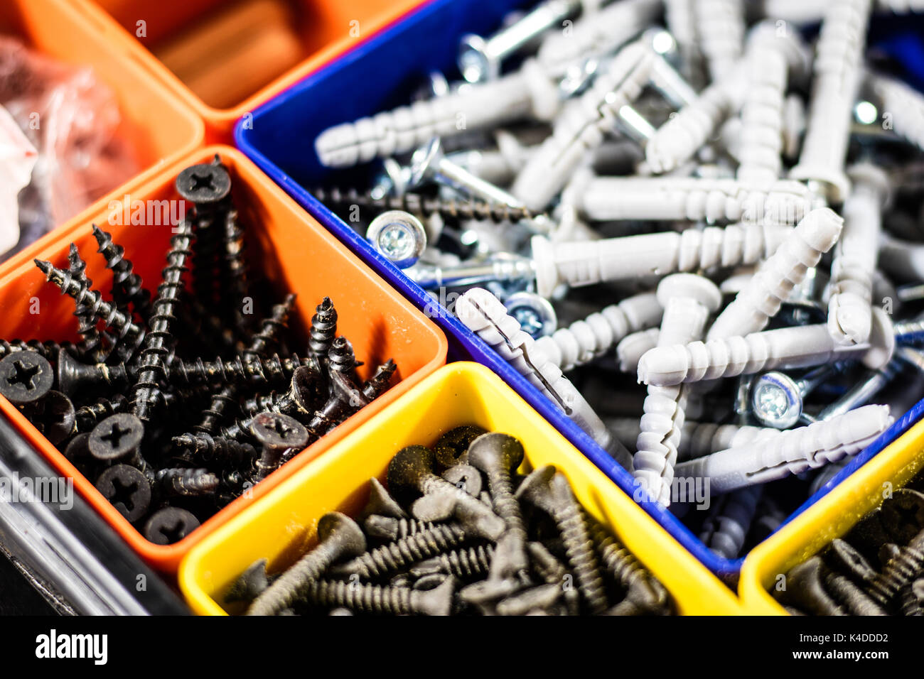 Screws segregated in plastic colored containers. Box for builder and ...
