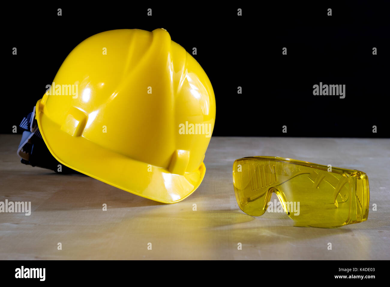 Yellow helmet, safety goggles and work gloves for the worker, black ...