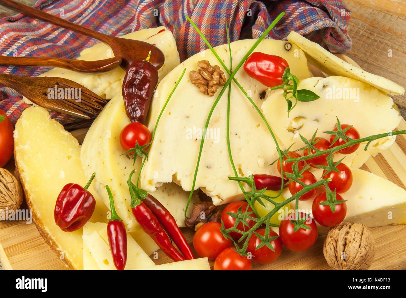 Sliced hard cheese on the kitchen board. Production of cheeses on the ...