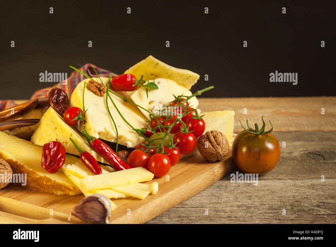 Sliced hard cheese on the kitchen board. Production of cheeses on the ...