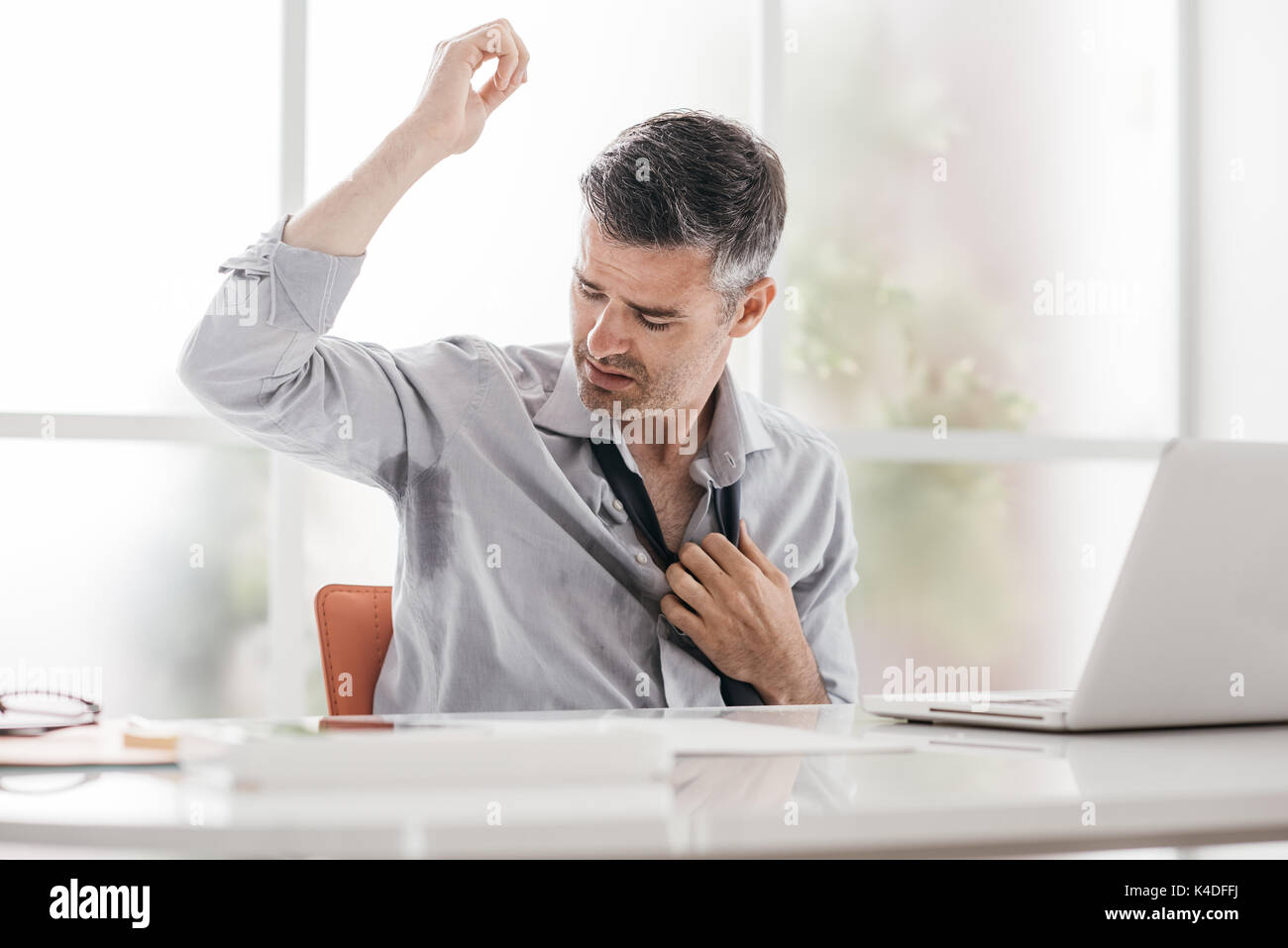 Nervous businessman working in the office, he is sweating and Stock ...