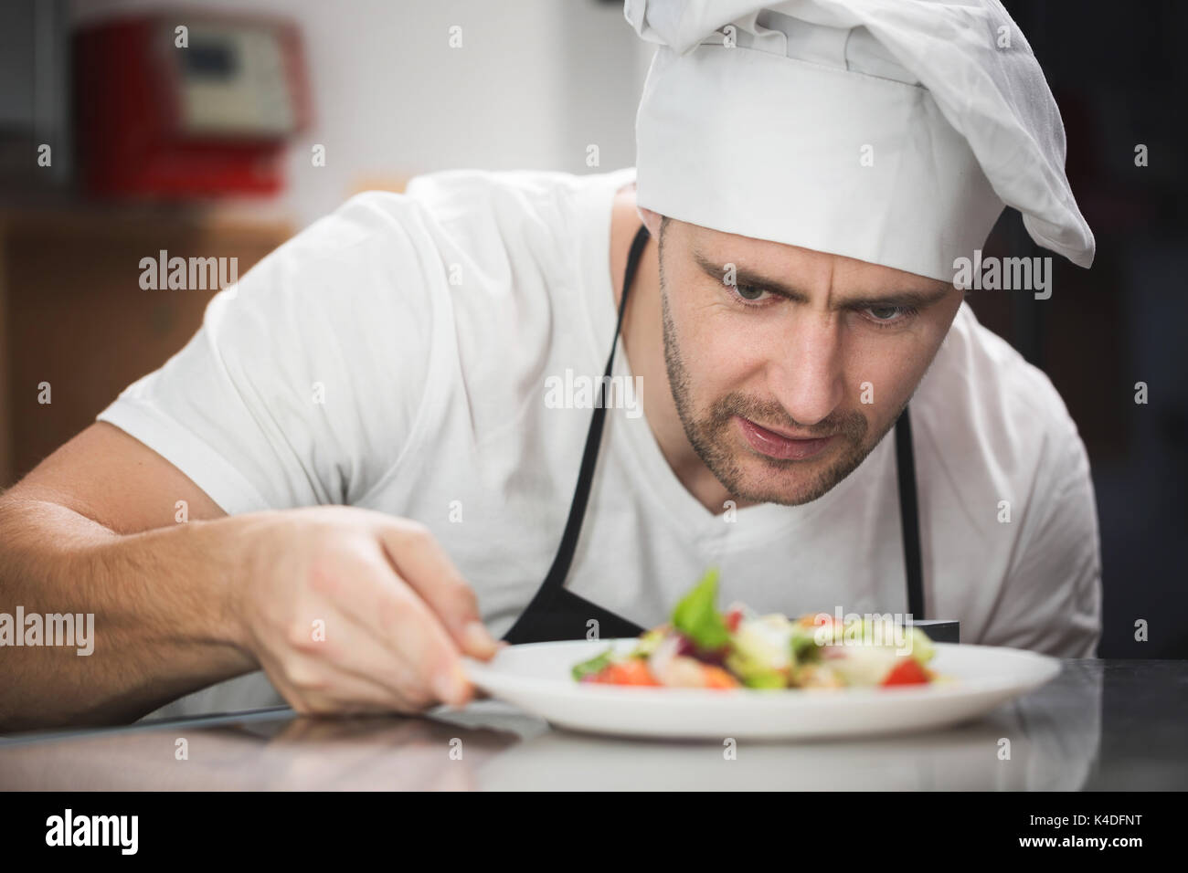 Close up portrait of chef preparing vegetable salad Stock Photo - Alamy