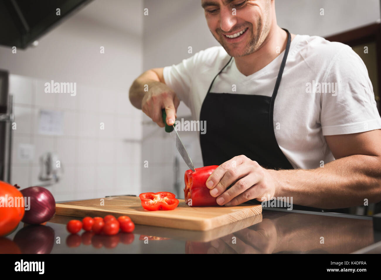 Cropped portrait of happy chef cutting vegetables for dinner Stock ...