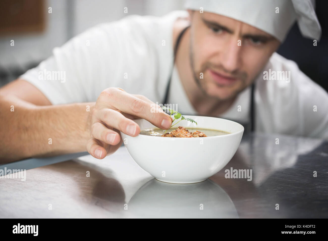 Close up portrait of chef decorating soup in kitchen Stock Photo - Alamy