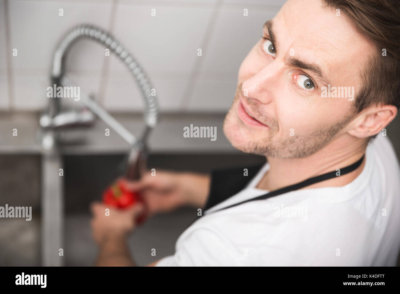Close up portrait from above of male chef washing vegetables Stock ...