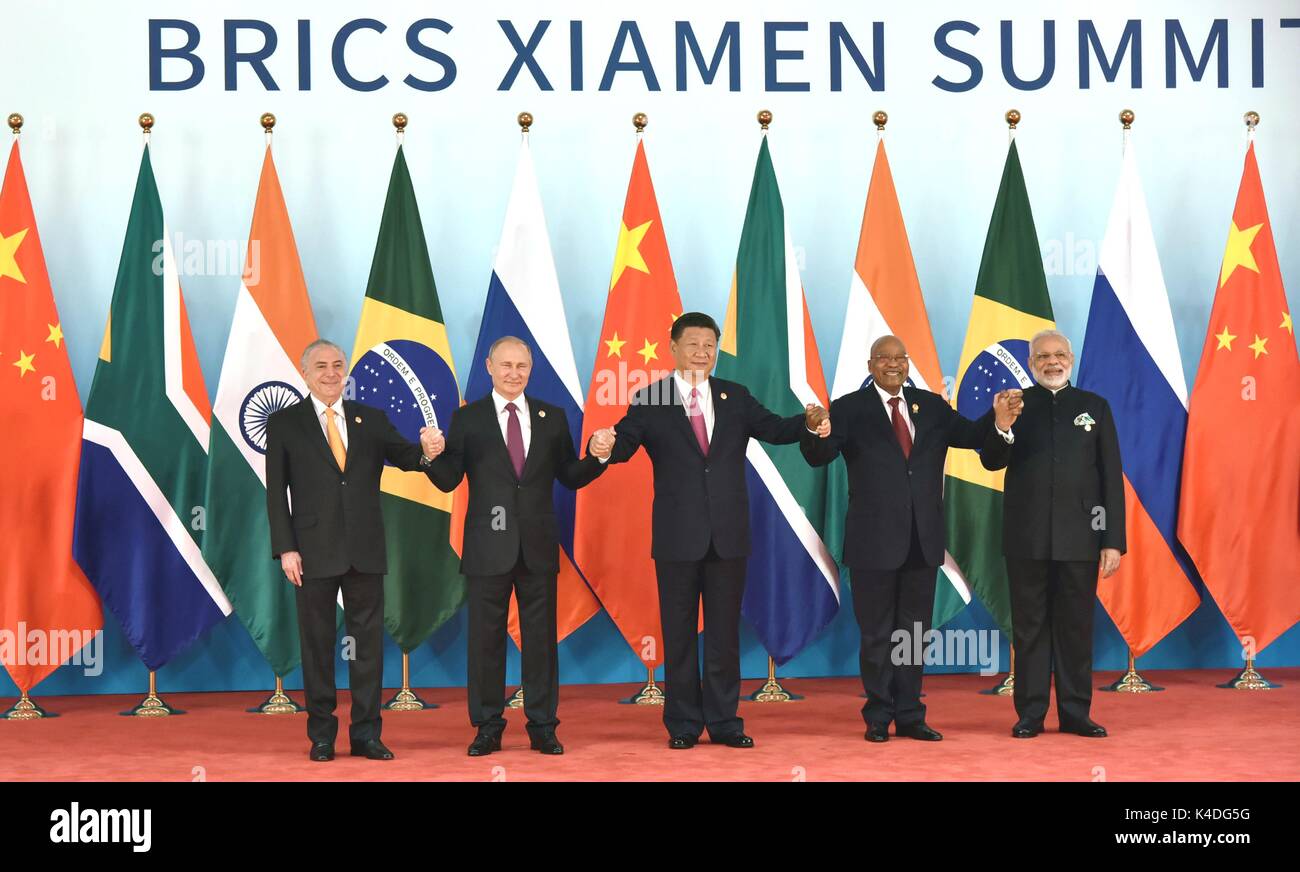 Leaders attending the BRICS Summit stand together for a family photo ...