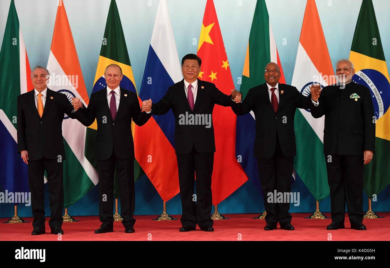 Leaders attending the BRICS Summit stand together for a family photo ...