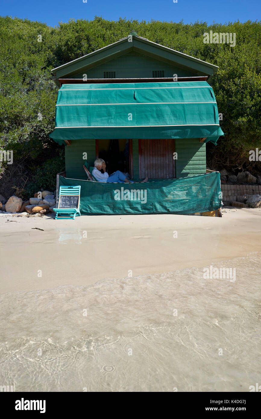Old woman sits on her terrace in front of her shack at the beach Stock ...
