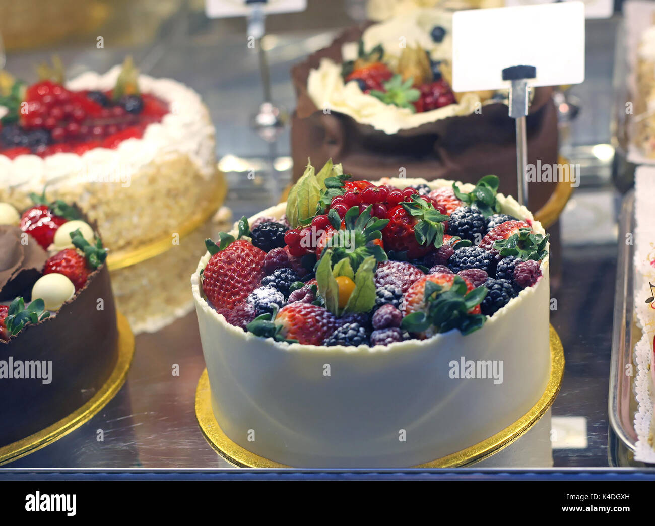 Tasty fruit cake in pastry shop window Stock Photo - Alamy