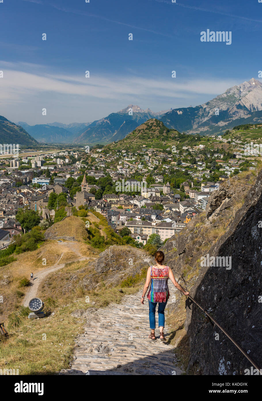 SION, SWITZERLAND - Tourist on path at Tourbillon Castle, and view of ...