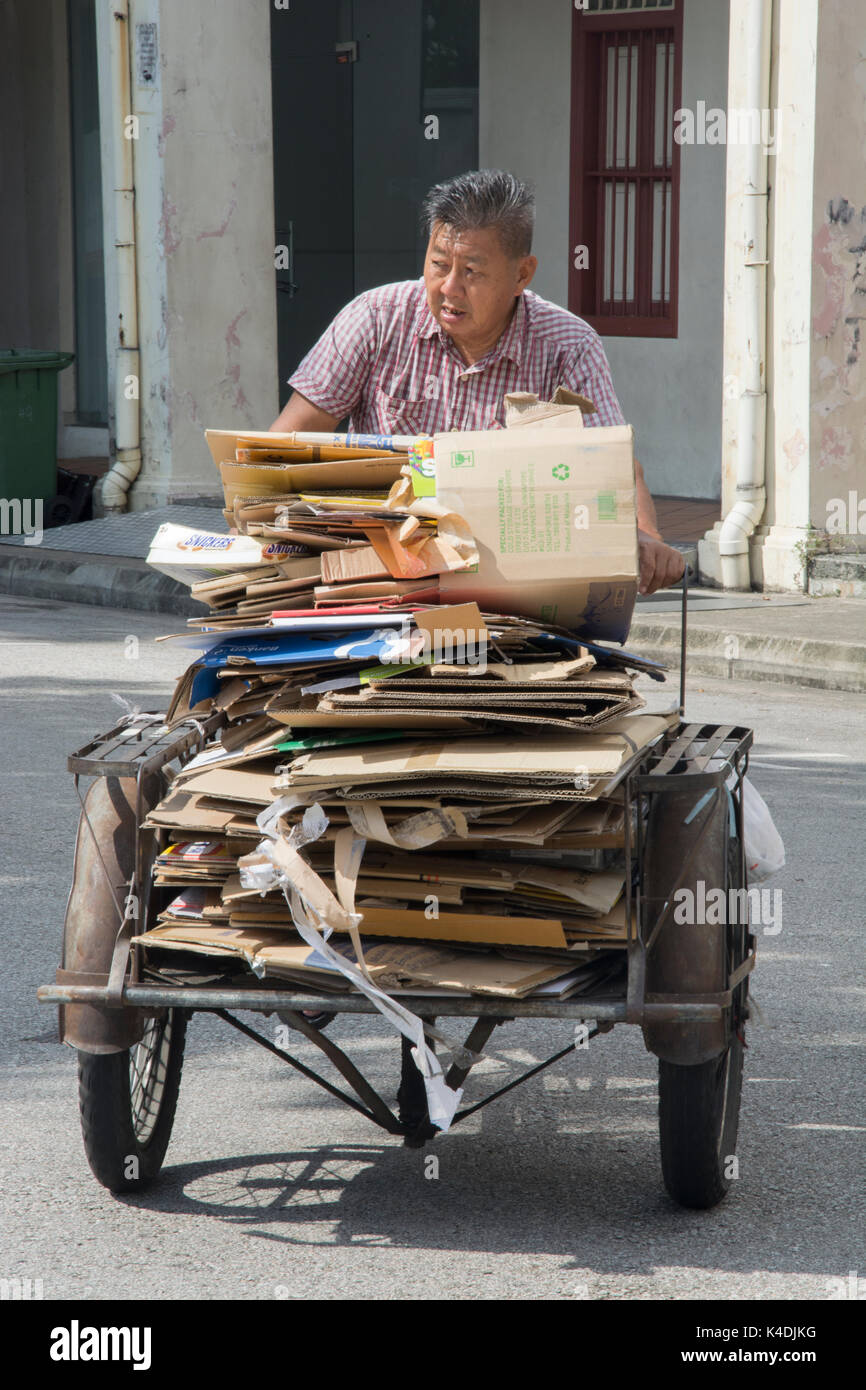 Chinese worker collecting scrap cardboard in Little India, Singapore ...