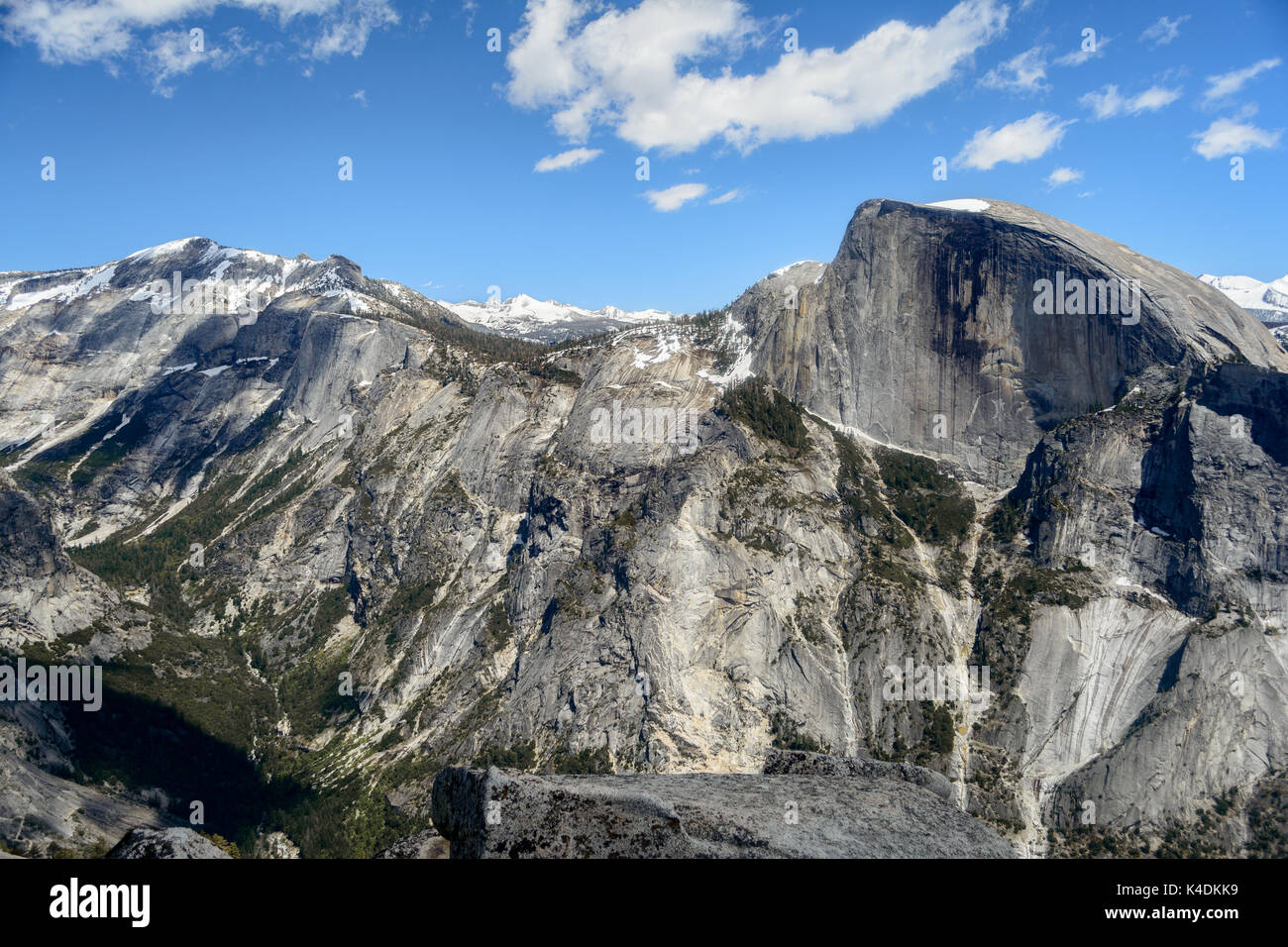 View of Half Dome and snowy mountains from the top of North Dome in ...