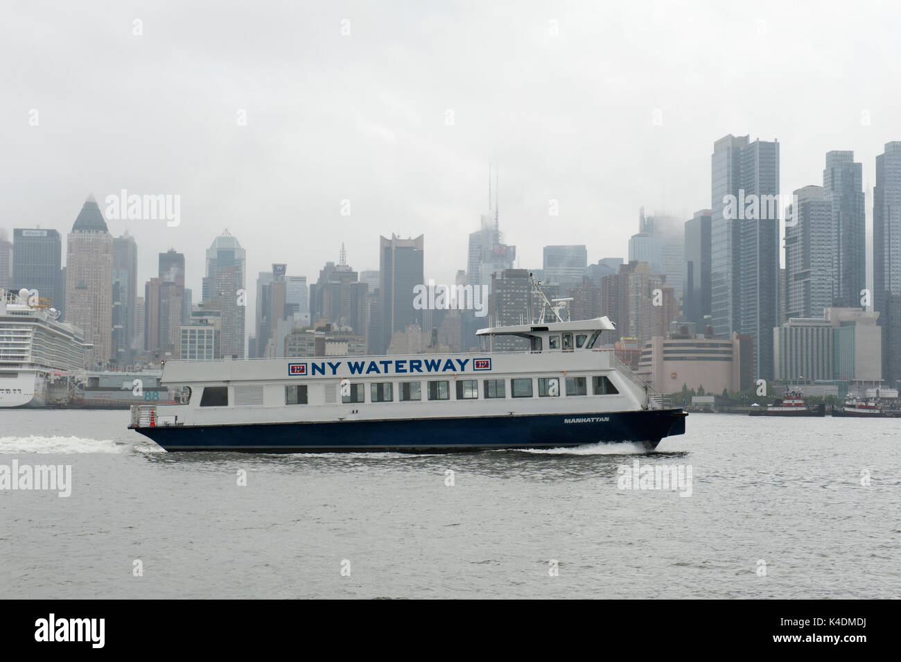 A New York Waterway ferry speeds down the Hudson River past the ...