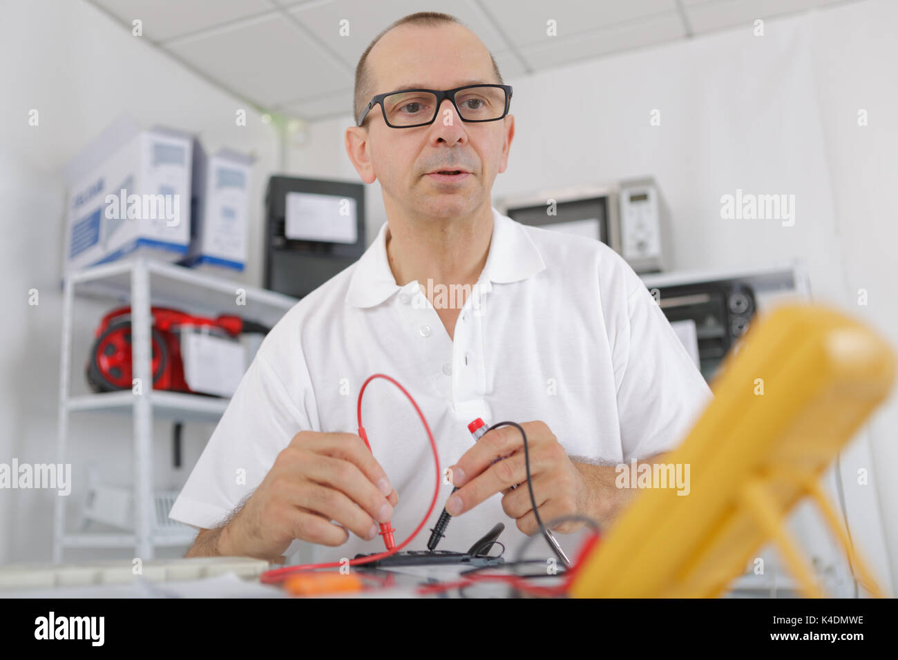 senior man calibrating with a digital multimeter Stock Photo - Alamy