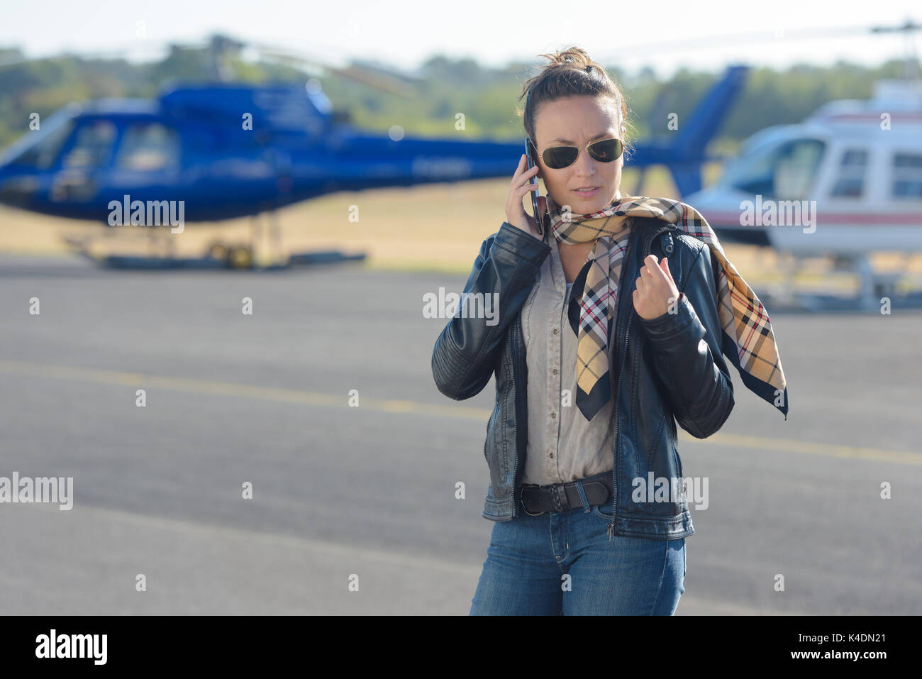 pretty pilot woman on helicopter background Stock Photo - Alamy
