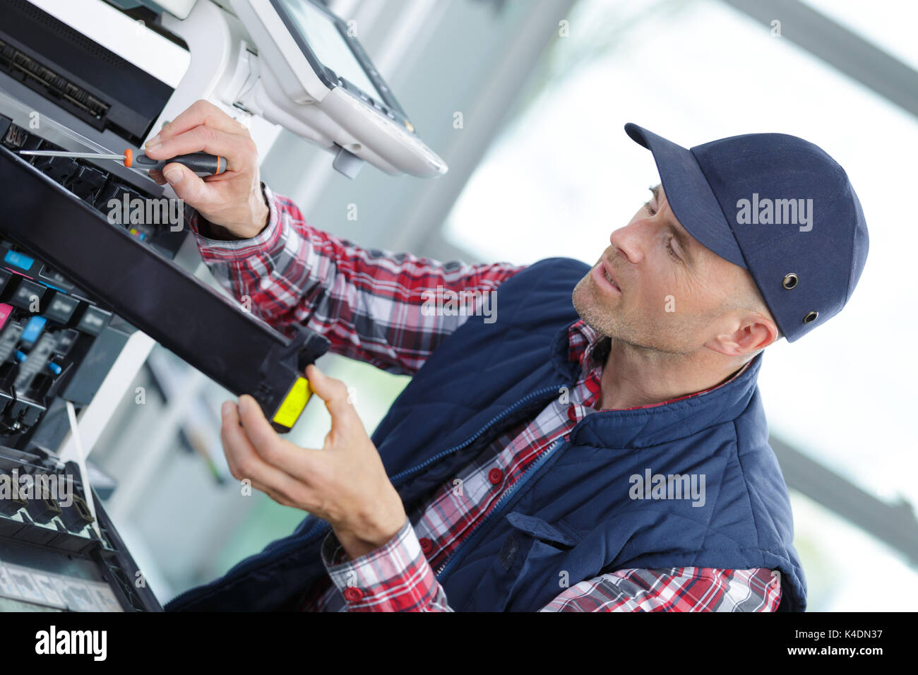 man fixing copier in the office Stock Photo - Alamy
