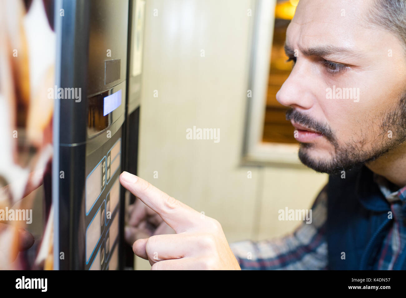 man pressing a vending machine Stock Photo - Alamy