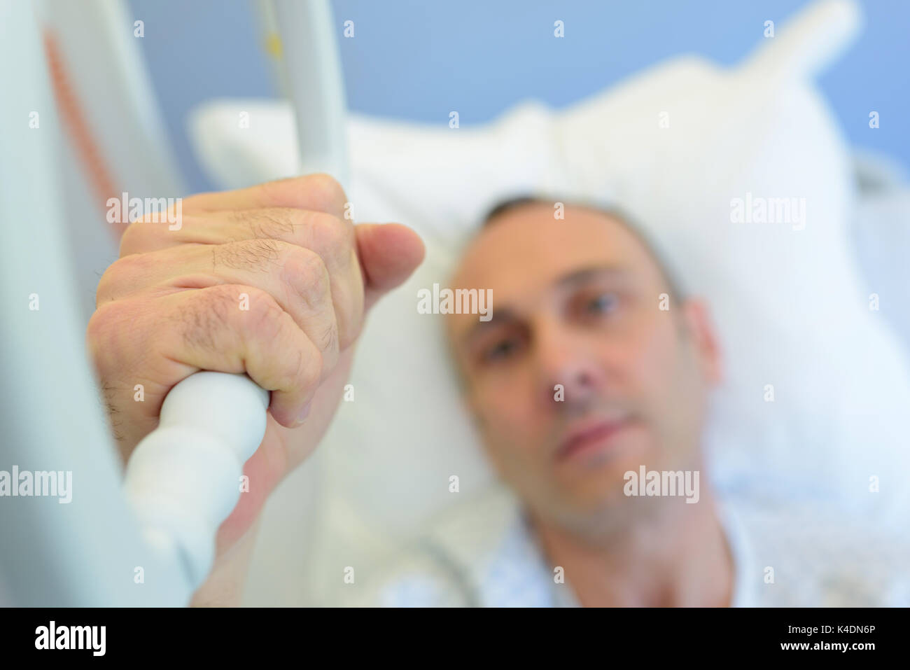 patient holding his hand on a hospital bed to recover Stock Photo - Alamy