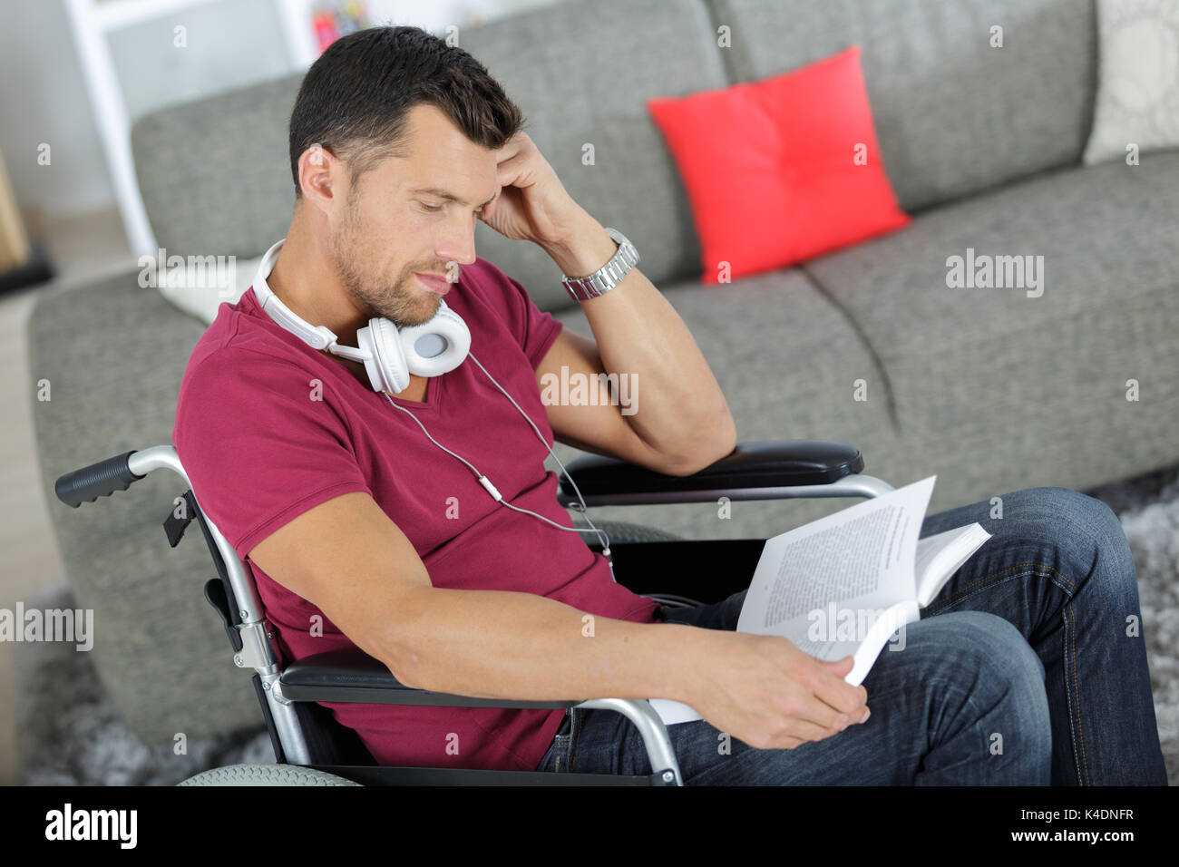 disabled man reading a book indoors Stock Photo - Alamy