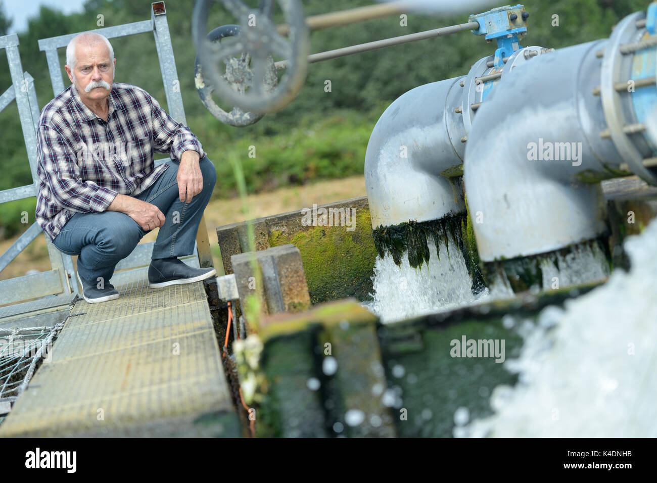 a workman inspecting a dam Stock Photo - Alamy