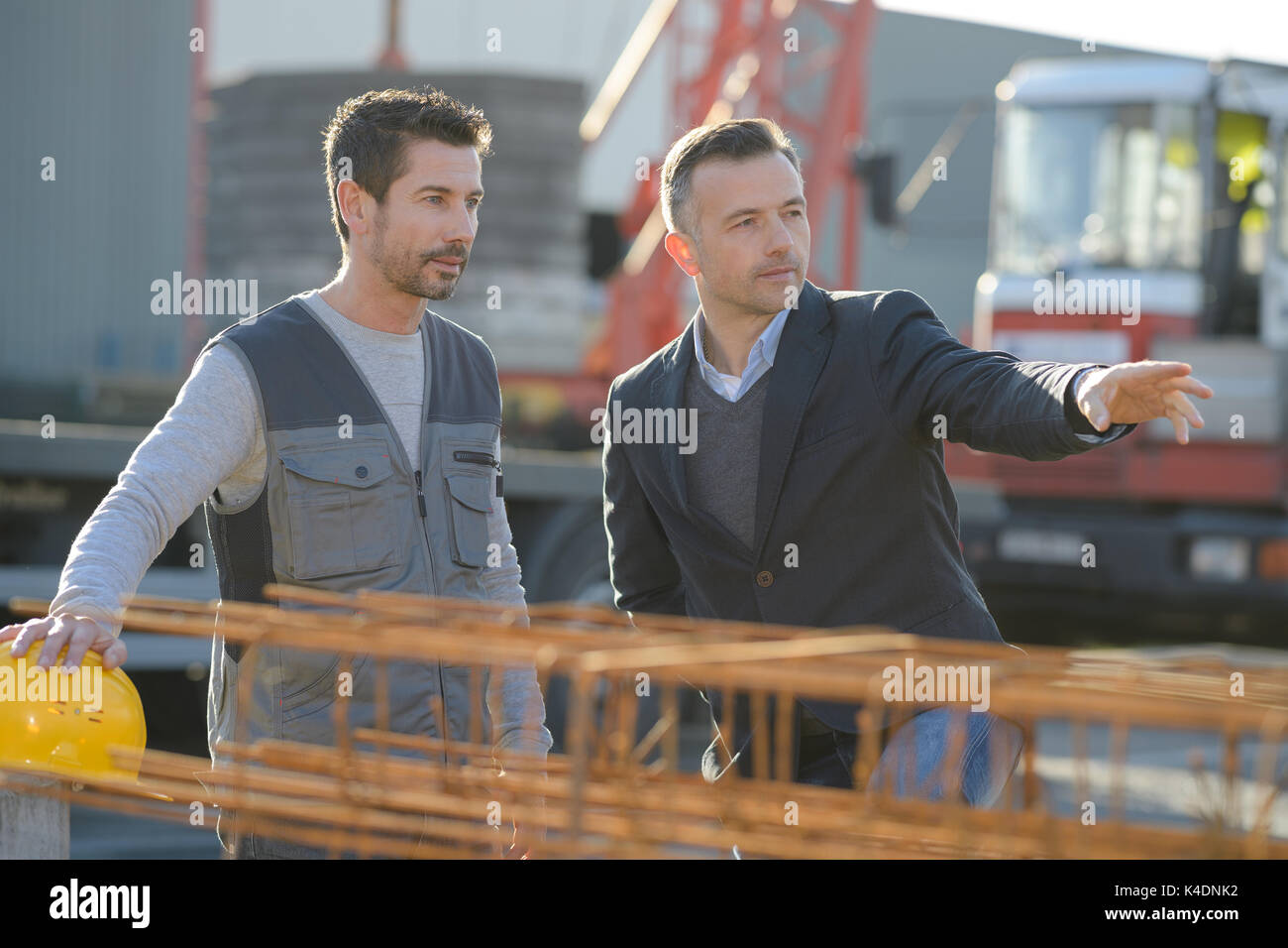 men having a conversation on the construction site Stock Photo - Alamy