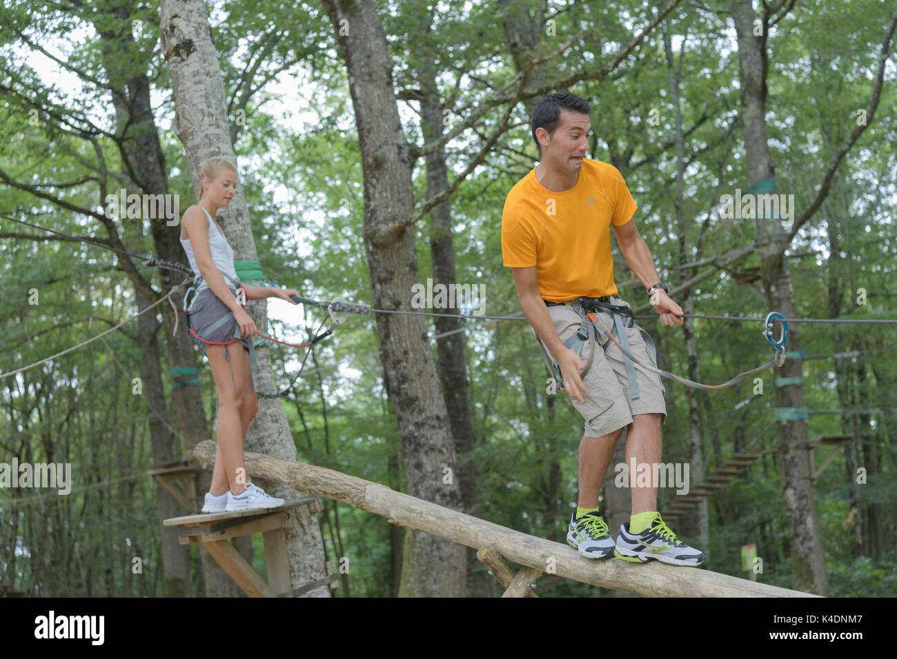 couple climbing rope at the adventure park Stock Photo - Alamy