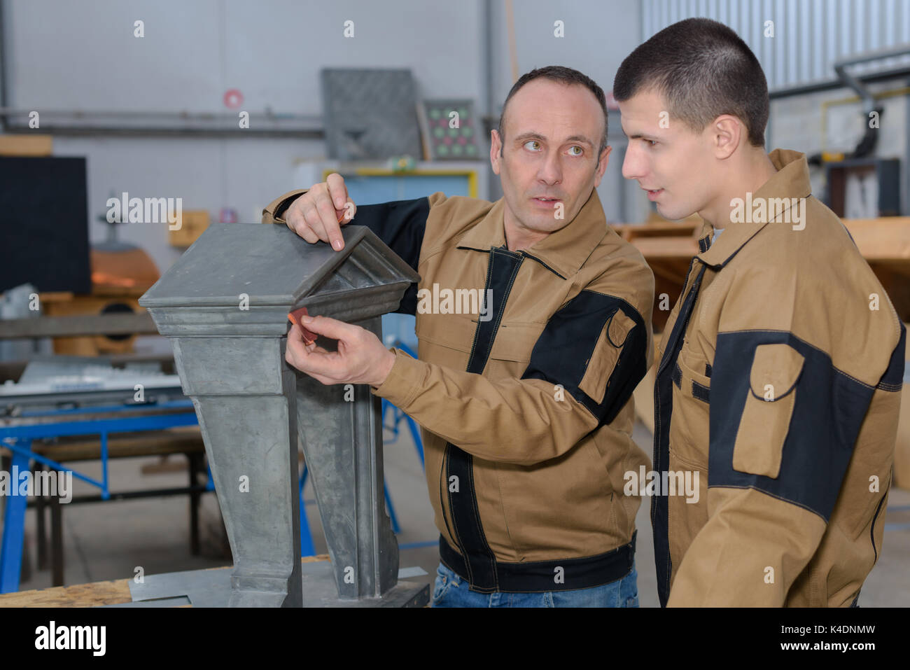 man in warehouse fixing something Stock Photo - Alamy