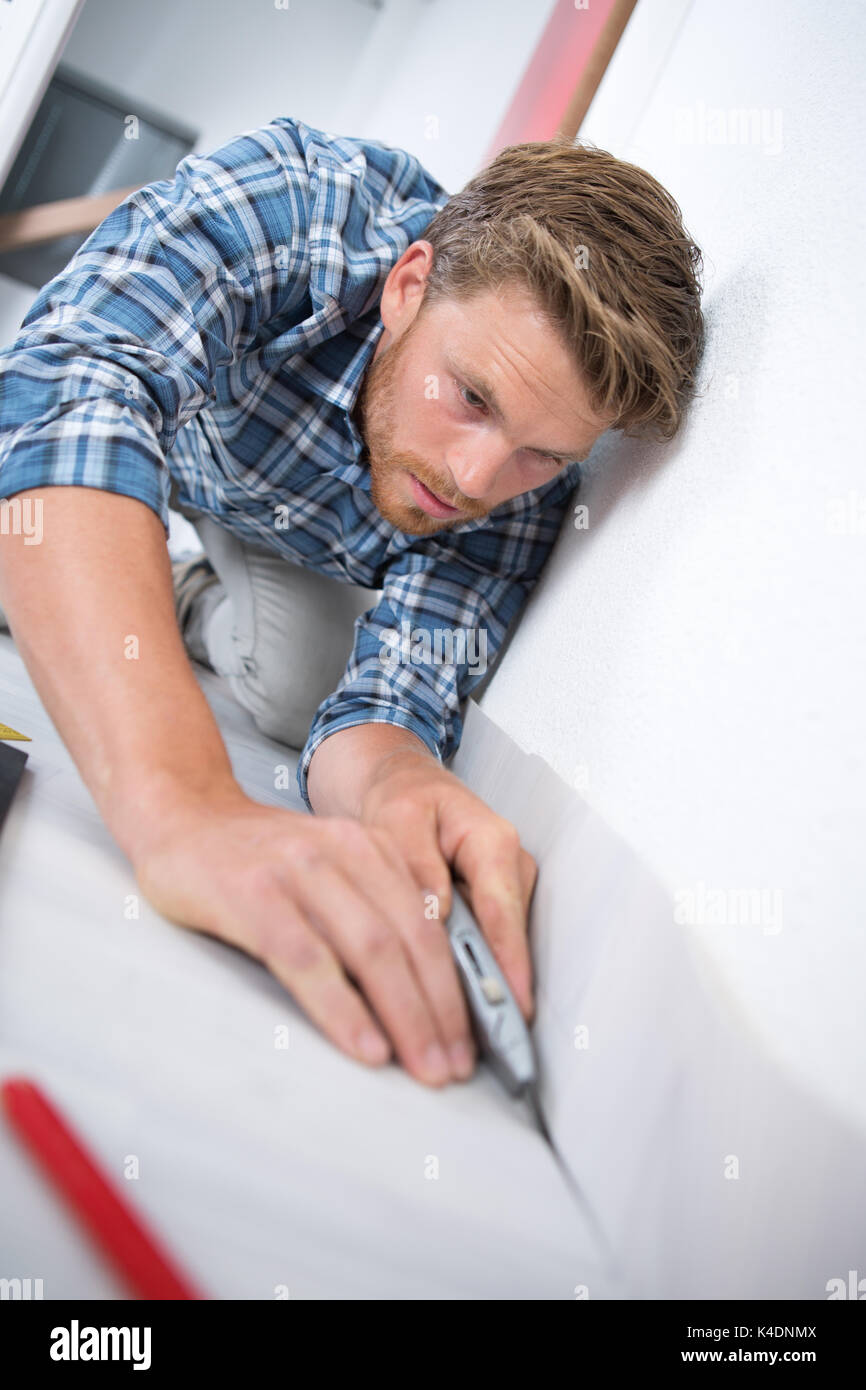 carpert fitter using cutter Stock Photo - Alamy