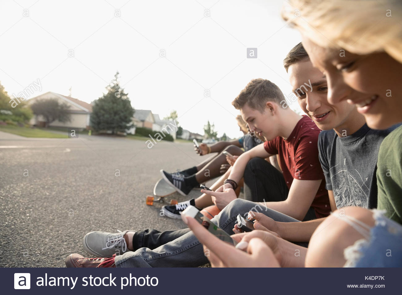 Girls row looking at mobile phones hi-res stock photography and images ...