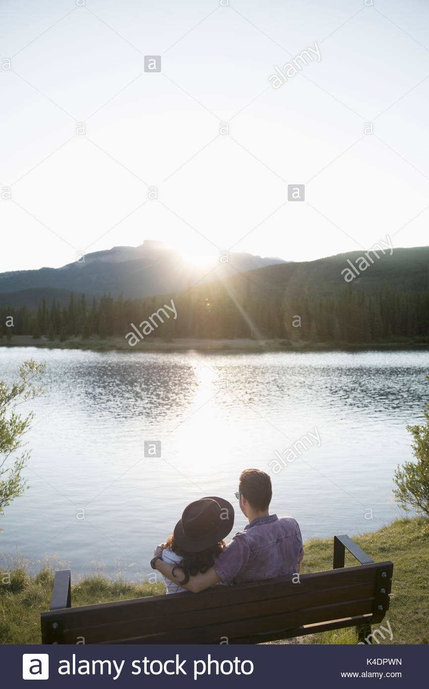 Couple sun on bench lake hi-res stock photography and images - Alamy