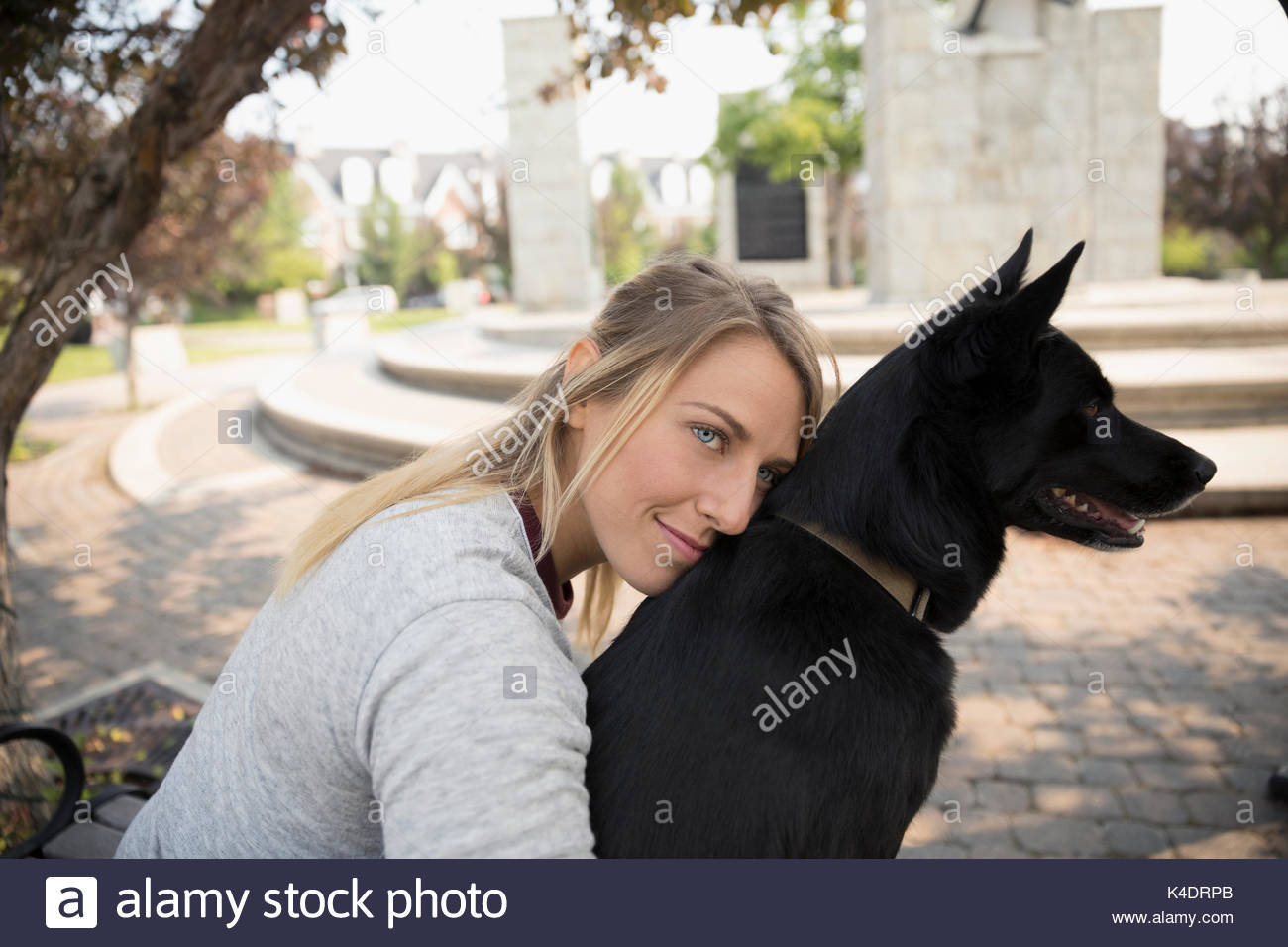 Woman hugging black dog hi-res stock photography and images - Alamy