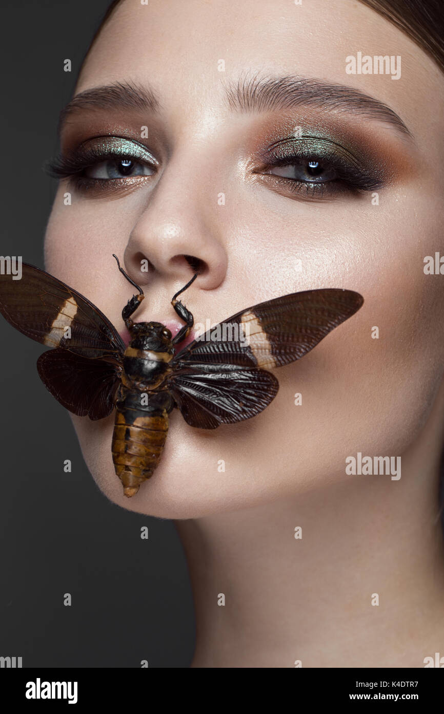 Portrait of beautiful girl with colorful make-up and cicada. Beauty ...